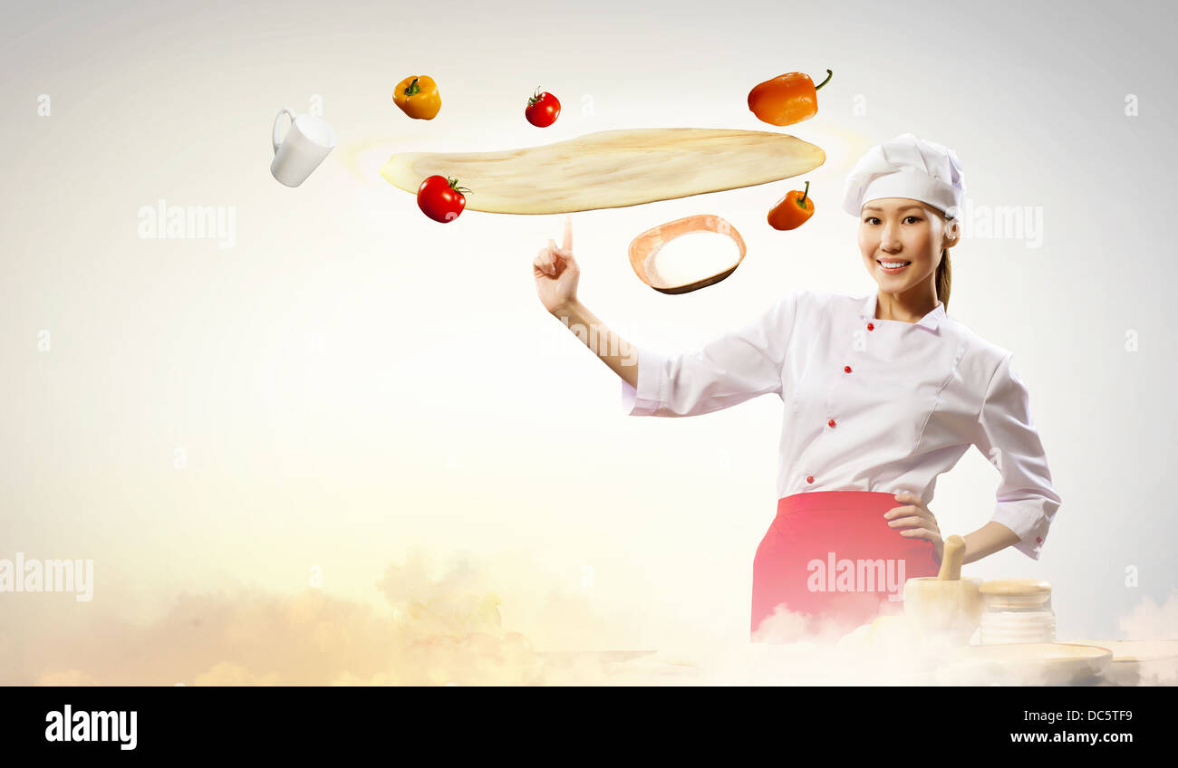 Asian female cook making pizza Stock Photo - Alamy