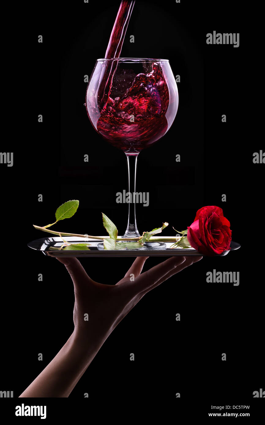 glass of red wine and red rose on black background Stock Photo - Alamy