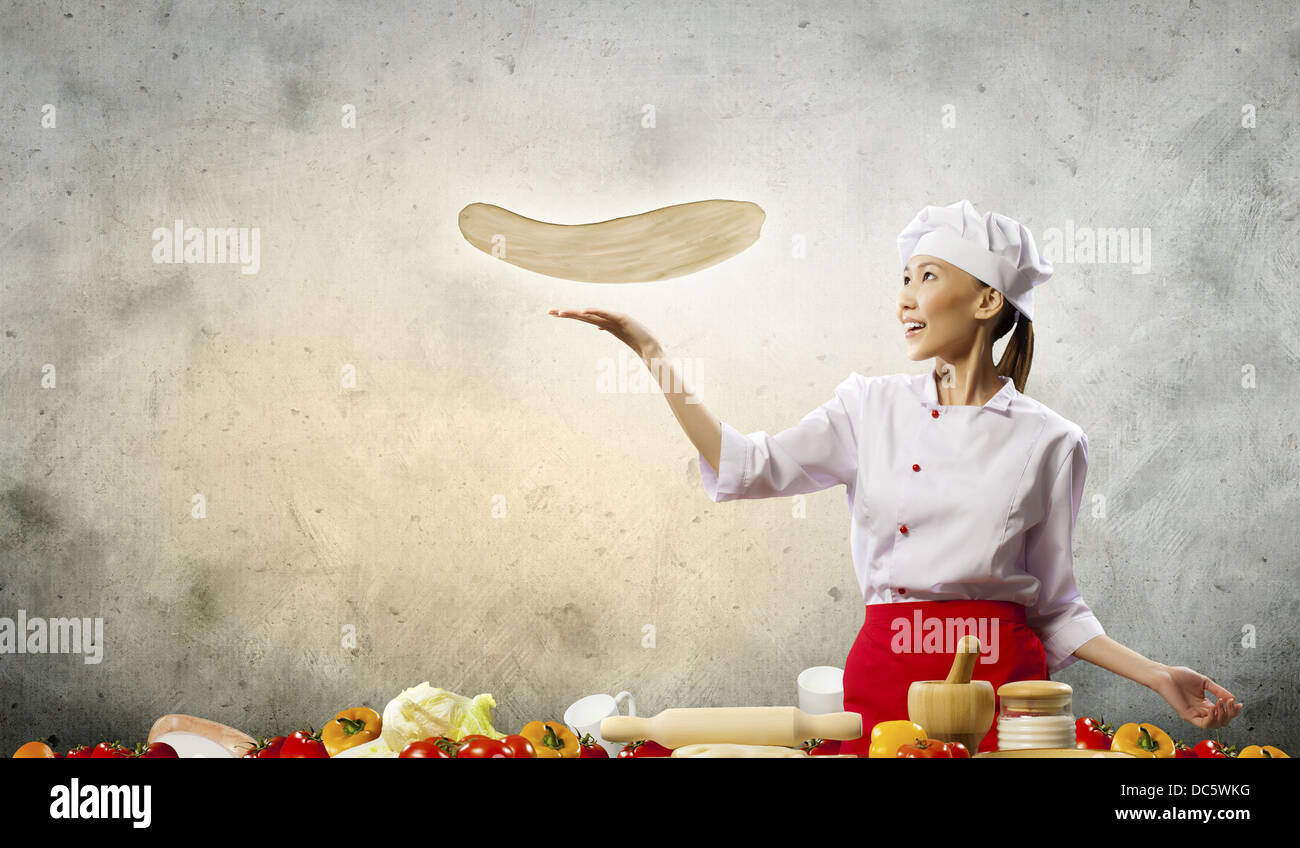 Asian female cook making pizza Stock Photo - Alamy
