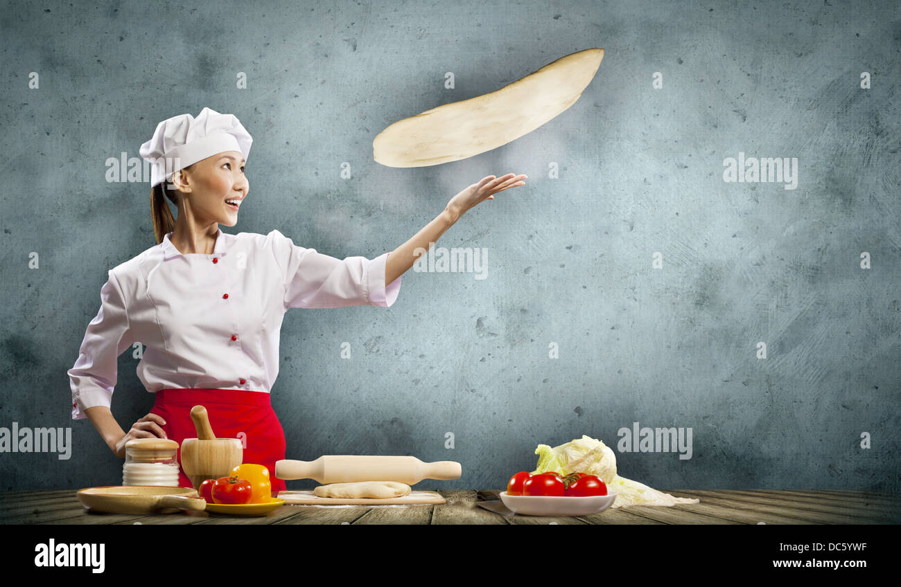 Asian female cook making pizza Stock Photo - Alamy