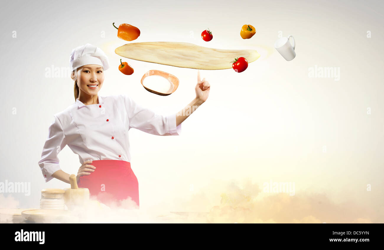 Asian female cook making pizza Stock Photo - Alamy