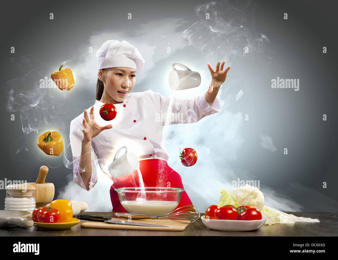 Asian female cooking with magic Stock Photo - Alamy