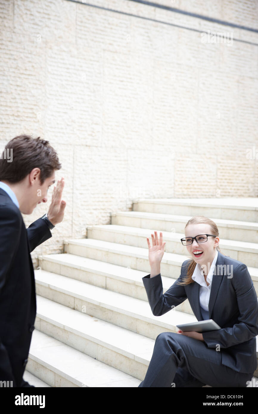 businesswoman saying hi to her colleague Stock Photo - Alamy