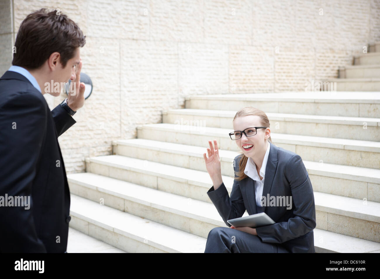 businesswoman saying hi to her colleague Stock Photo - Alamy