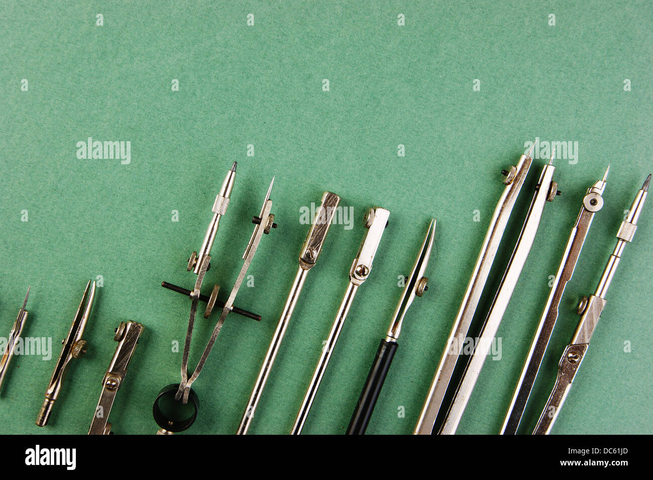 Old drawing tools on a green background Stock Photo - Alamy