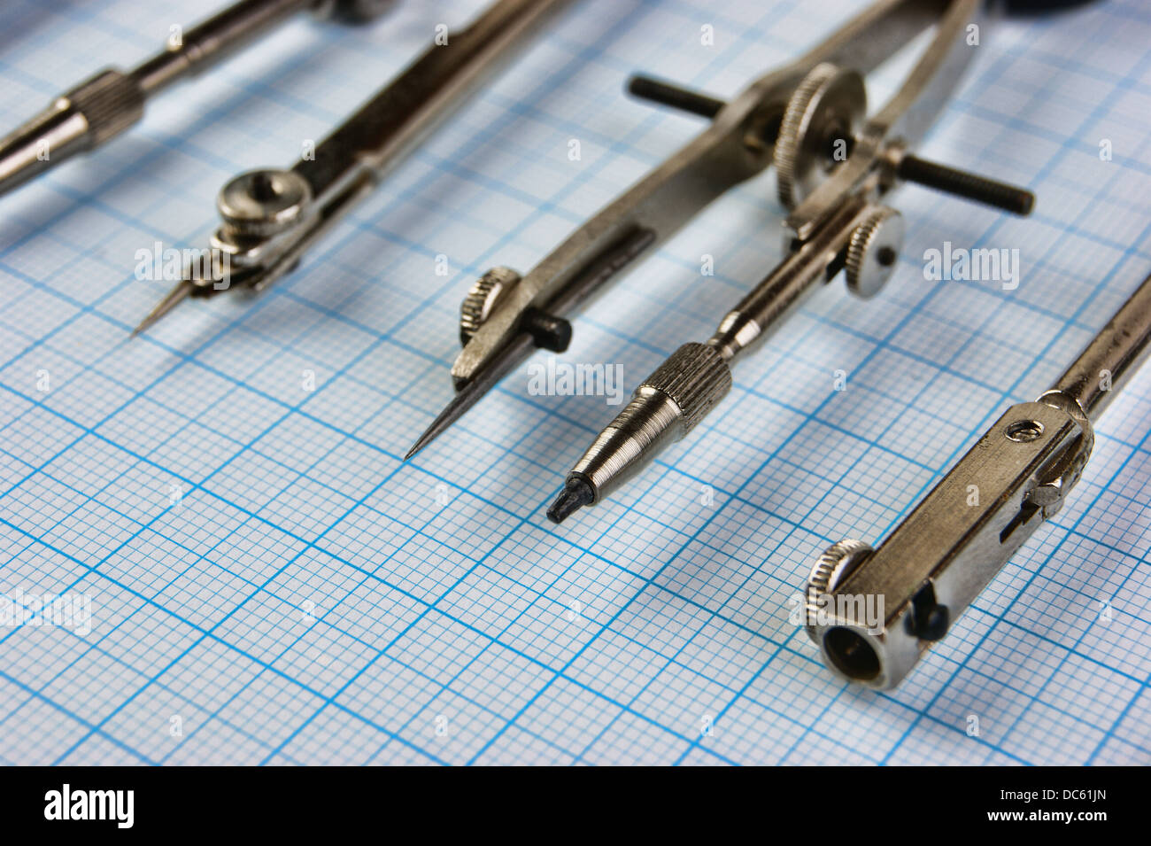 Old drawing tools on graph paper Stock Photo - Alamy
