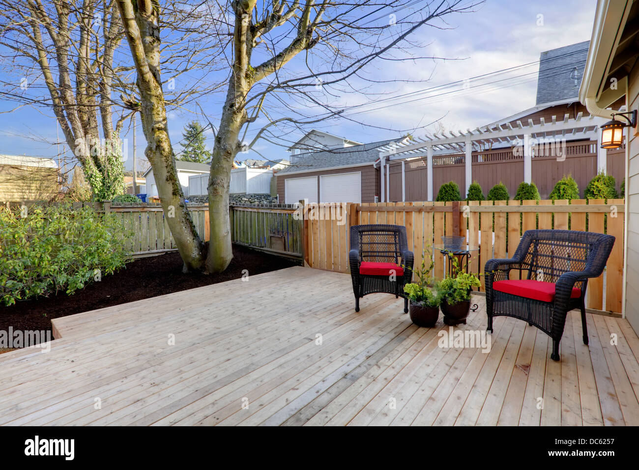 Deck with two chairs and fenced yard near home exterior shot Stock ...