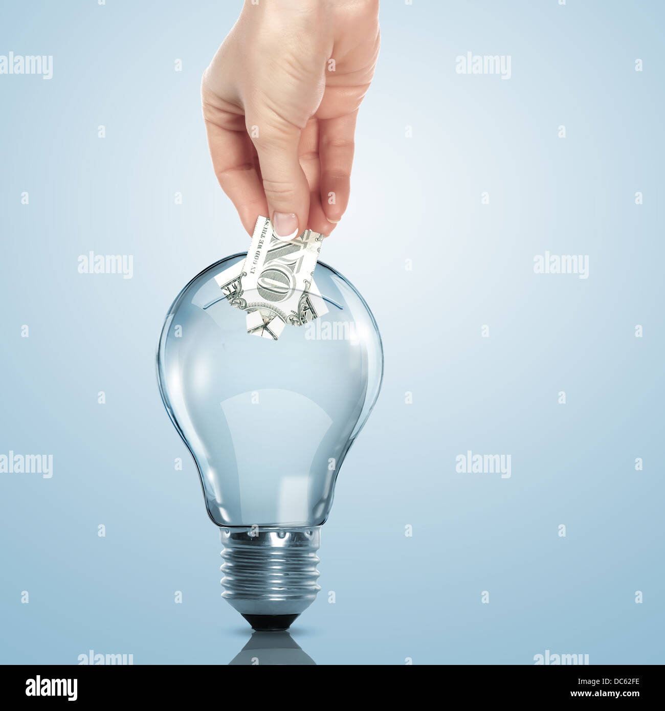 Money inside an electric light bulb Stock Photo - Alamy
