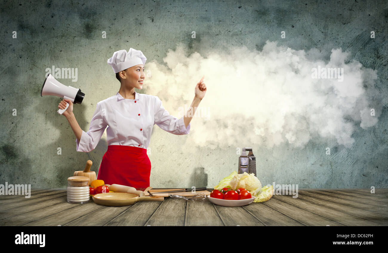 Asian female cook holding megaphone Stock Photo - Alamy