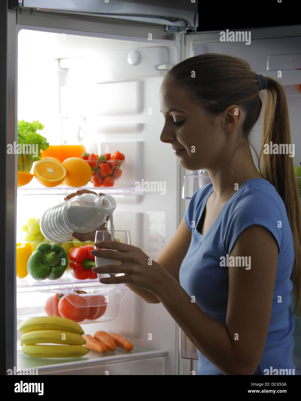 Woman pour out milk Stock Photo - Alamy