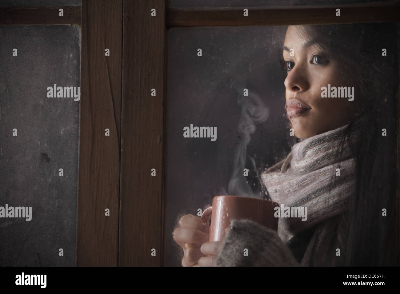 Portrait of a beautiful woman behind window with a cup of coffee Stock ...