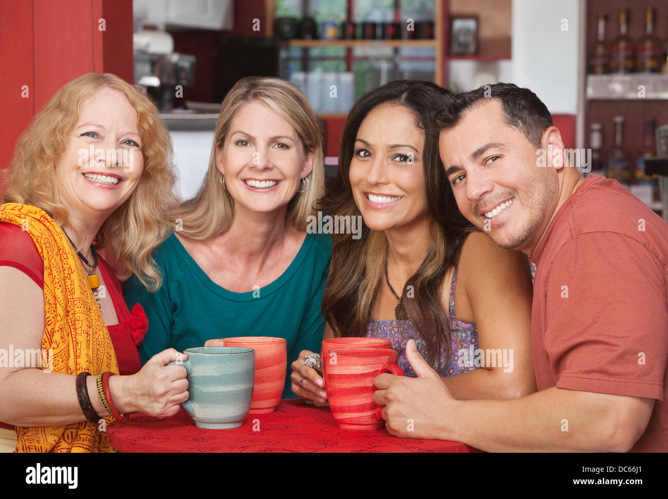 Happy Friends at Cafe Table Stock Photo - Alamy