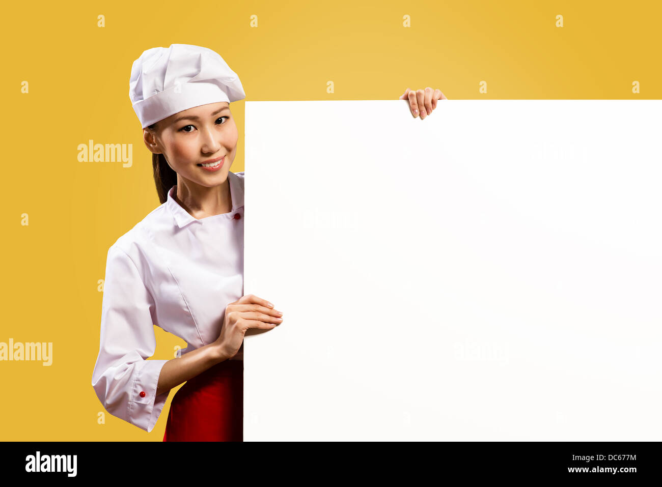 Asian female chef holding poster for the text Stock Photo - Alamy