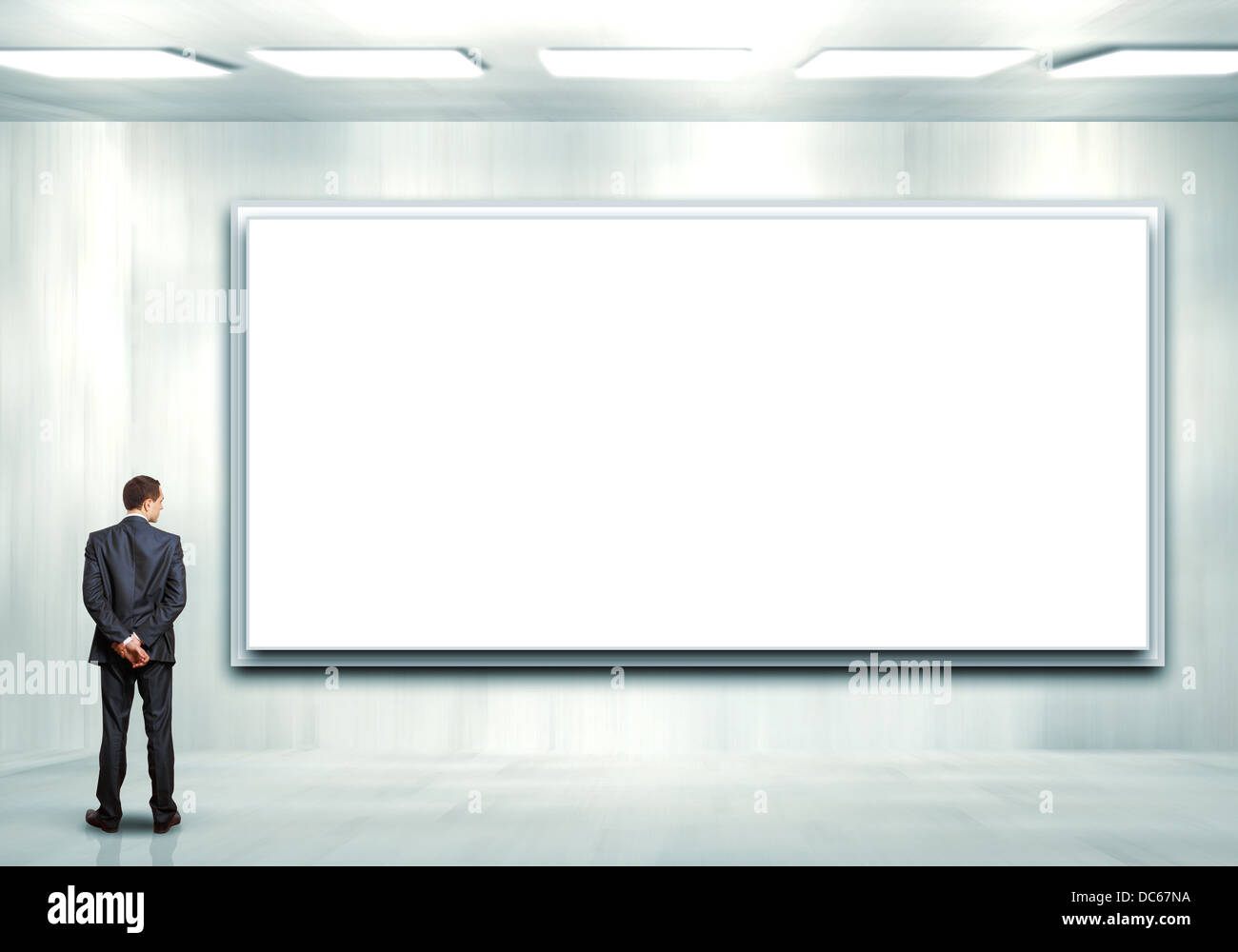 Business person standing near a blank billboard Stock Photo - Alamy