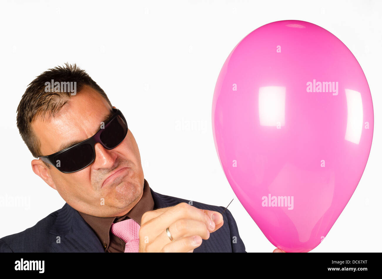 Mafia like guy about to burst a balloon Stock Photo - Alamy