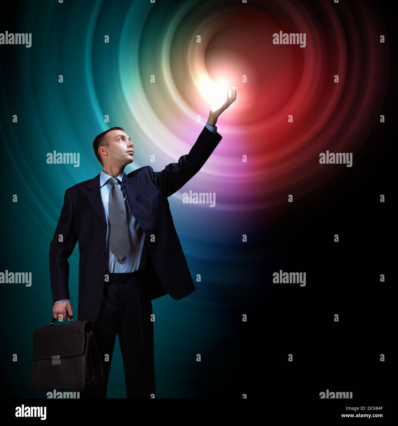 Businessman with light shining Stock Photo - Alamy