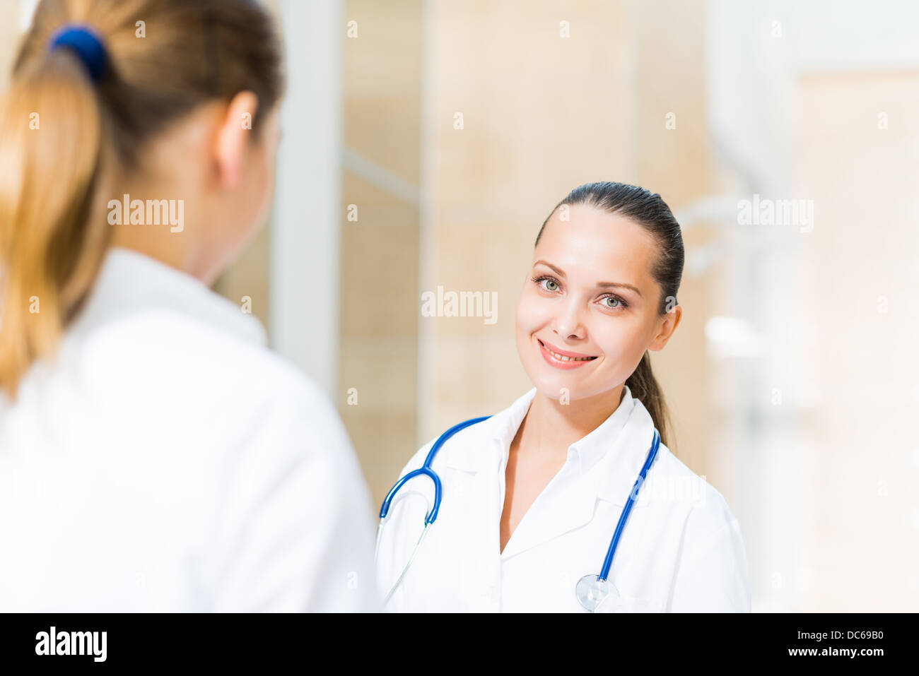 two doctors talking in the lobby Stock Photo - Alamy