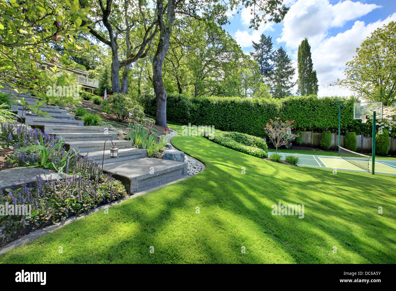 Tennis court with house landscape and bright green grass Stock Photo ...