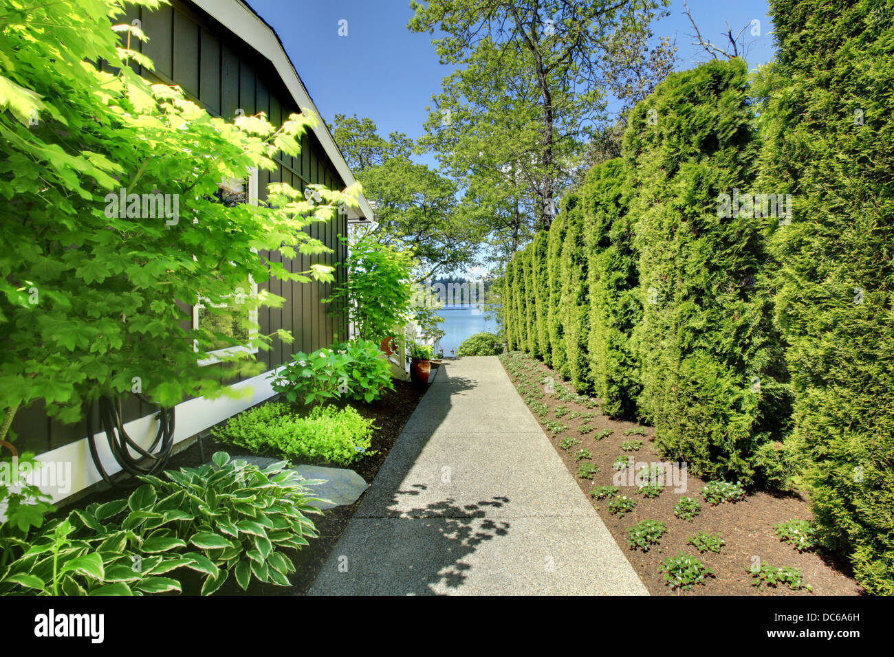 Side of the house with green landscape and walkway Stock Photo - Alamy