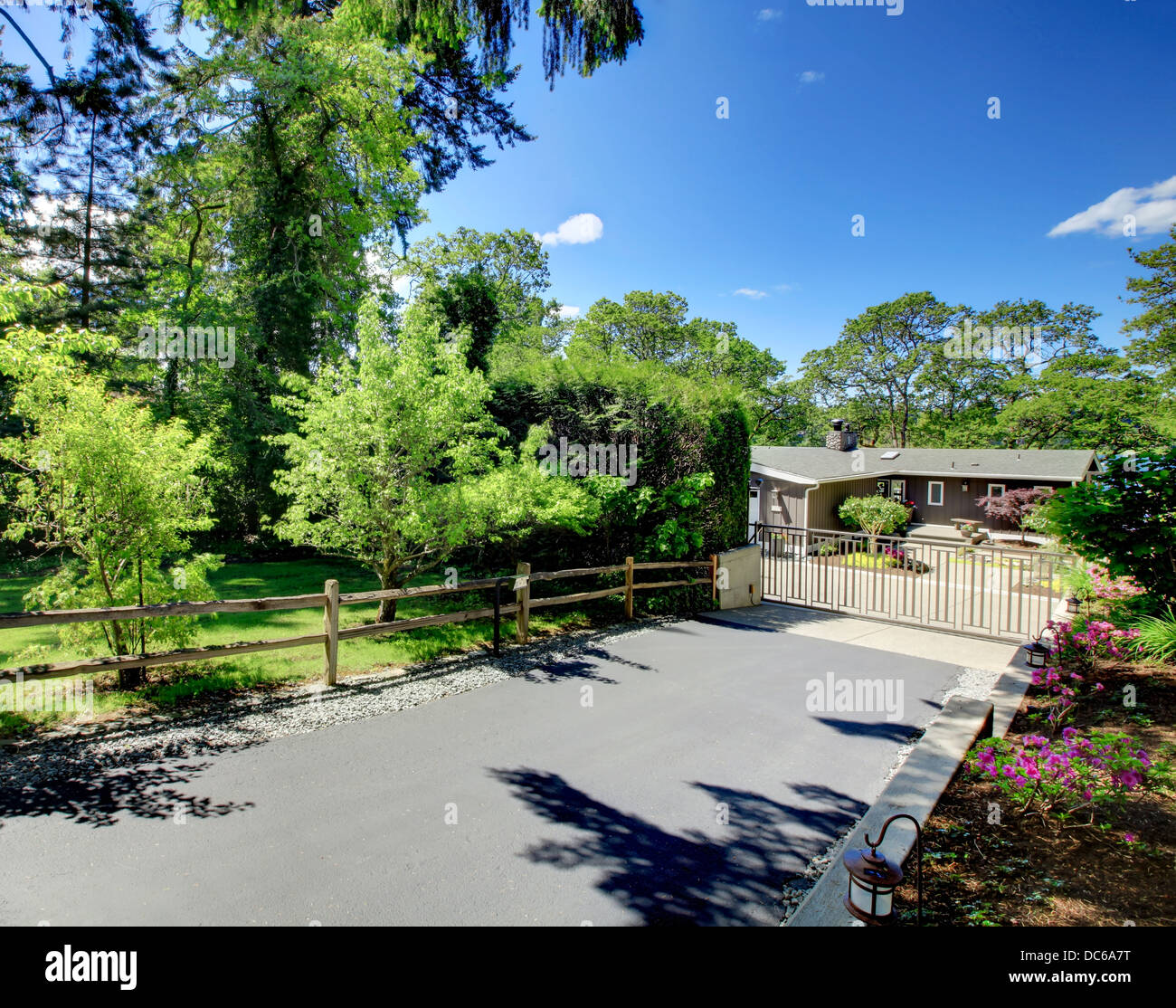 Beautiful home with private gates, driveway and garden Stock Photo - Alamy