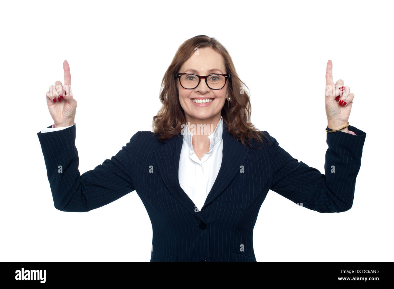 Smiling corporate woman pointing upwards Stock Photo - Alamy