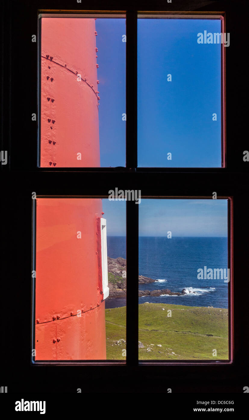 Looking out window at detail of red metal Ferryland, Newfoundland ...