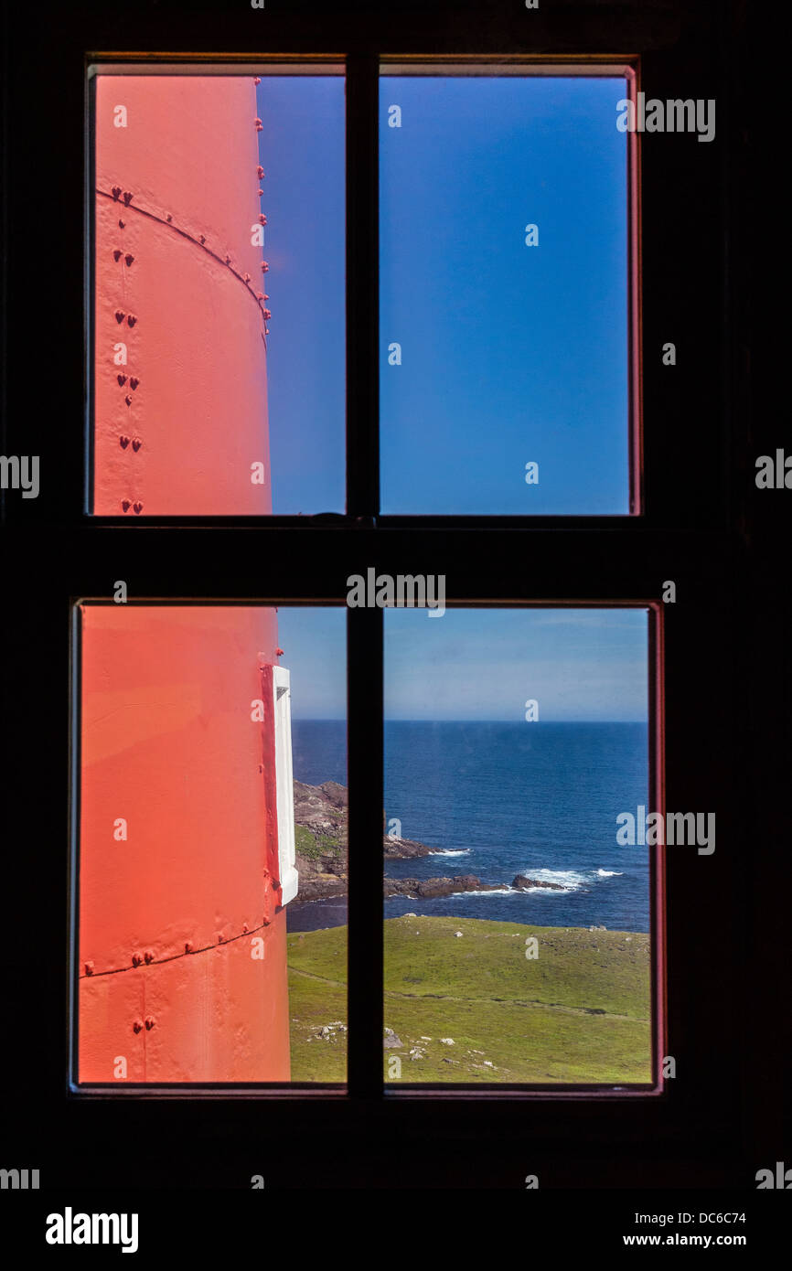 Looking out window at detail of red metal Ferryland, Newfoundland ...
