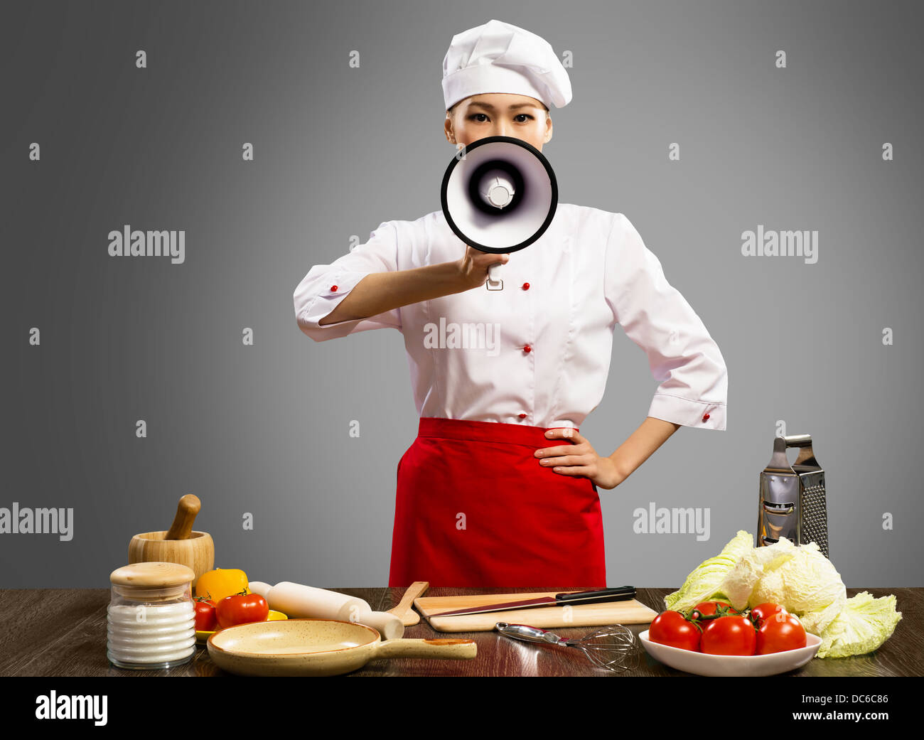 Asian female chef holds a megaphone Stock Photo - Alamy