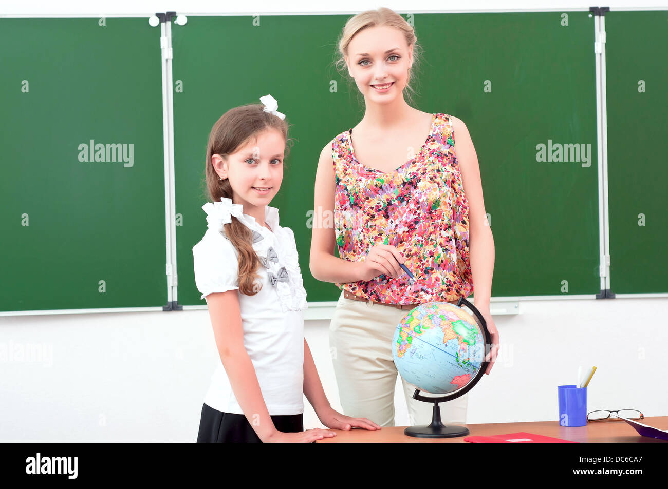 teacher explains the lesson in geography Stock Photo - Alamy