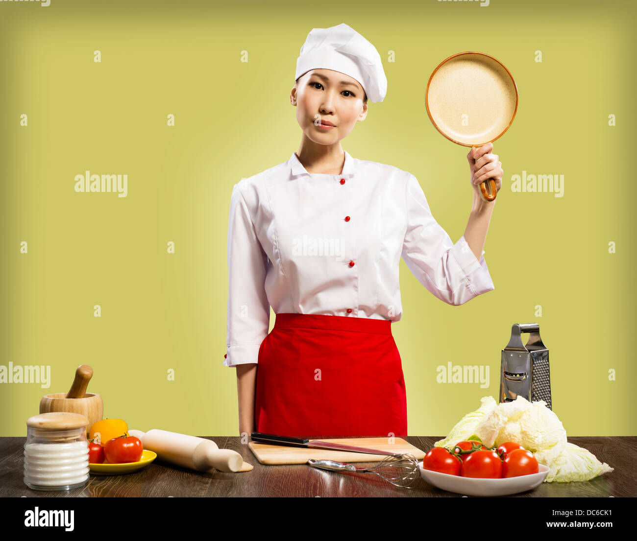 Chinese woman chef holding a ceramic pan Stock Photo - Alamy