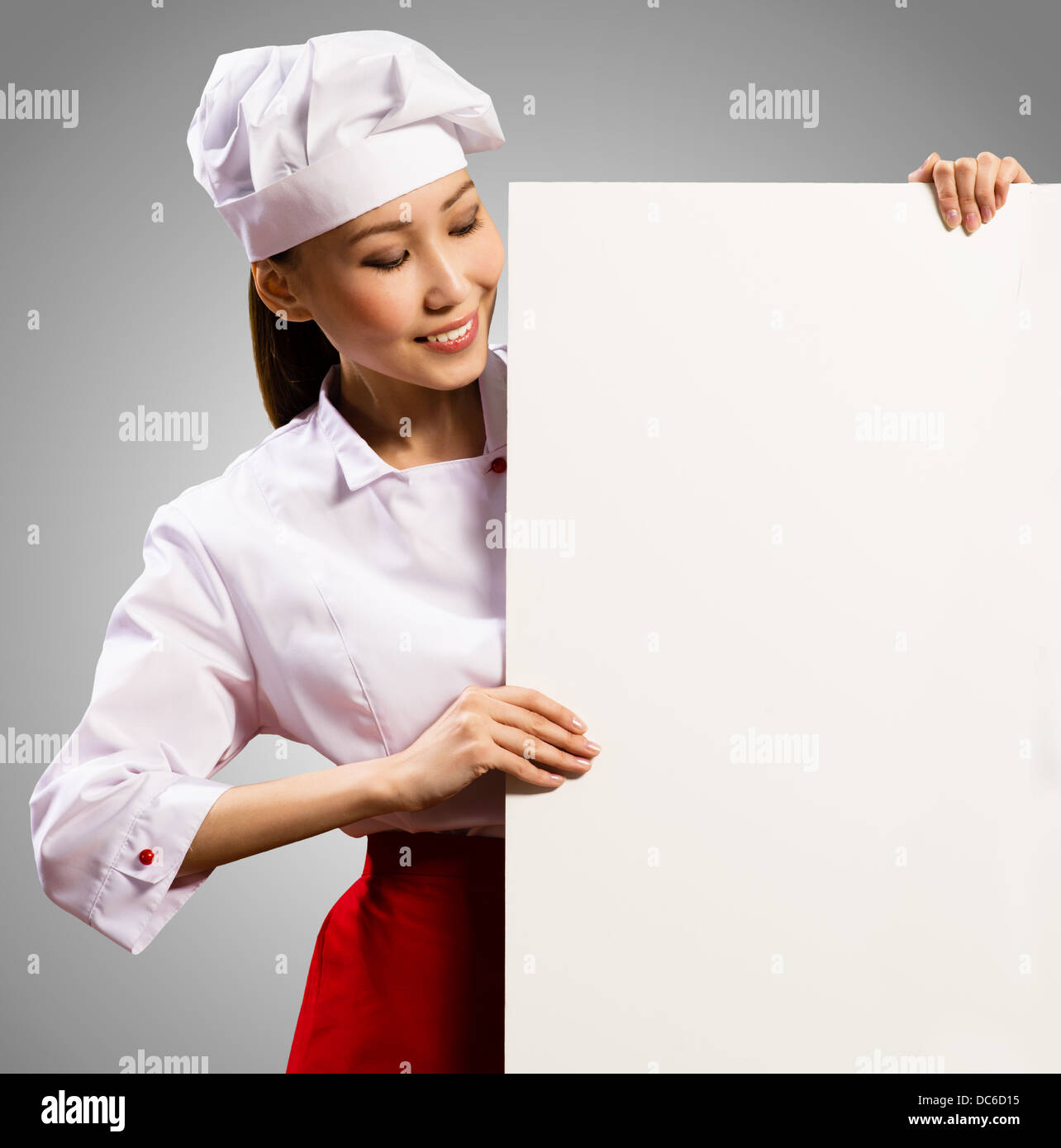 female chef holding a poster for text Stock Photo - Alamy