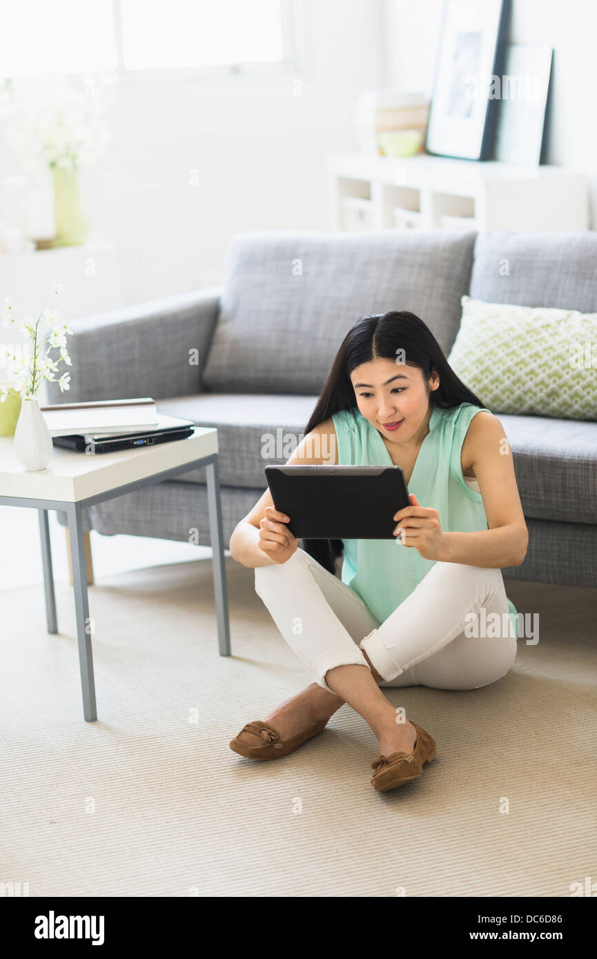 Young woman sitting home tablet hi-res stock photography and images - Alamy