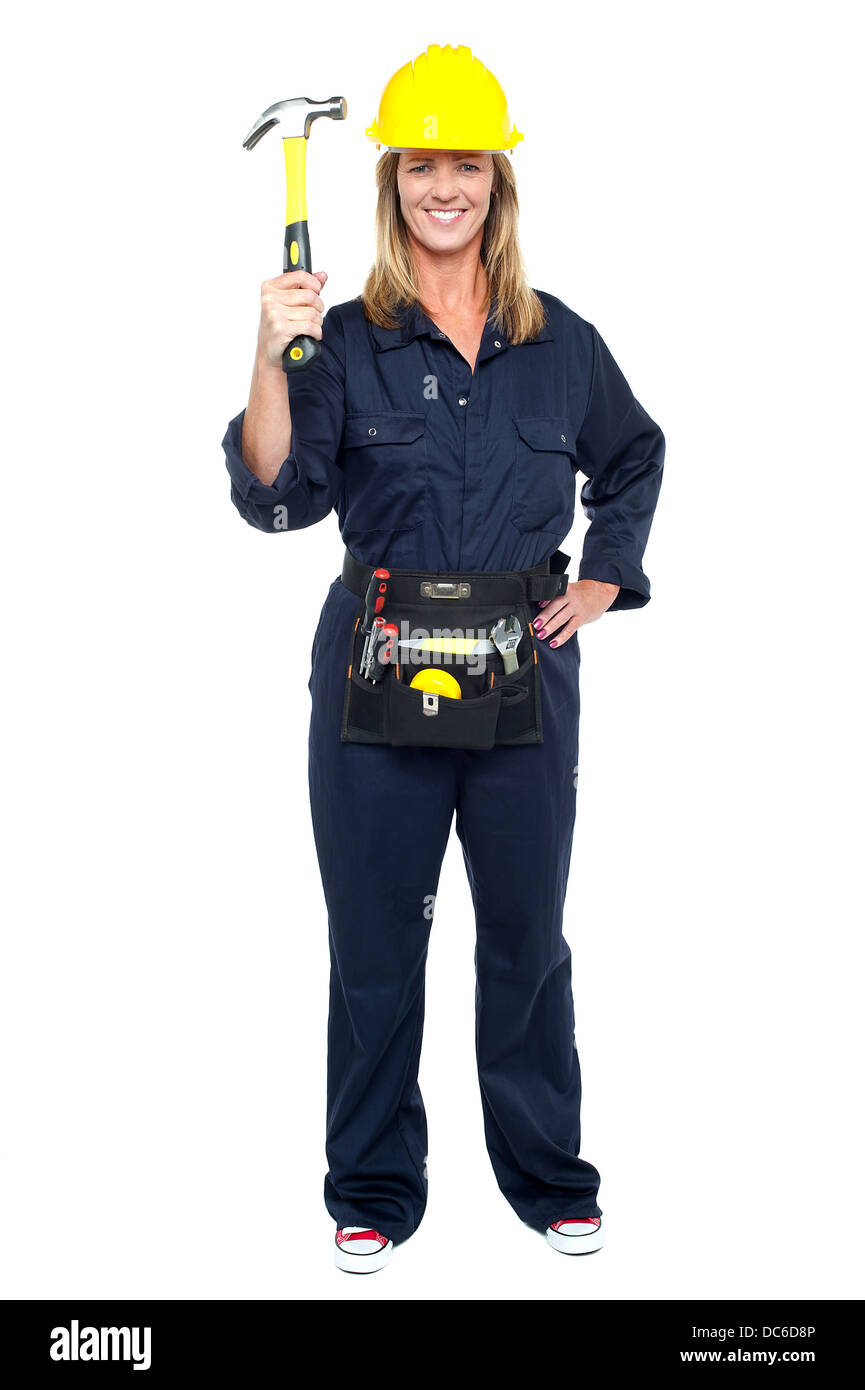 Smiling constrution worker displaying hammer Stock Photo - Alamy