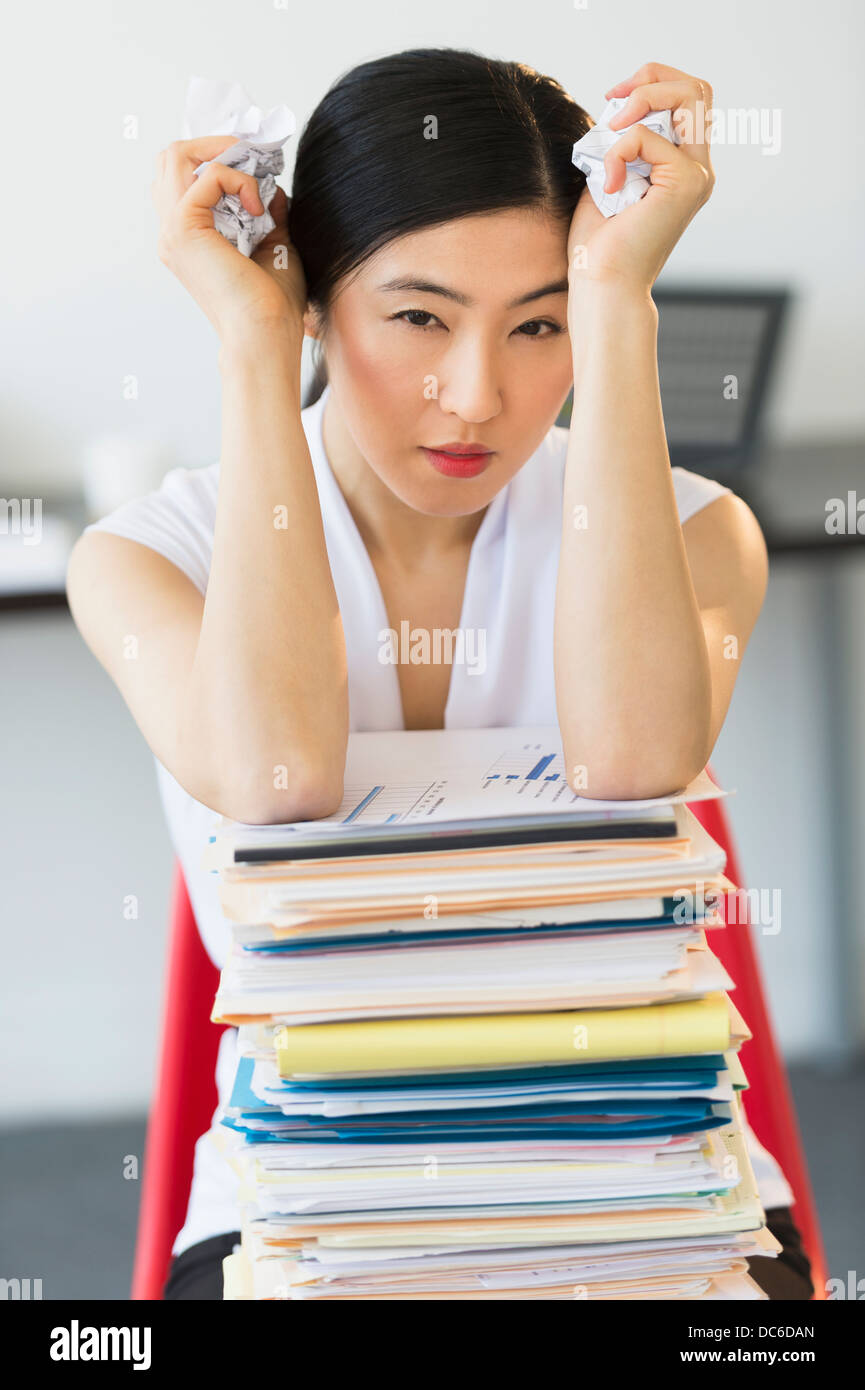 Portrait of businesswoman with stack of files Stock Photo - Alamy