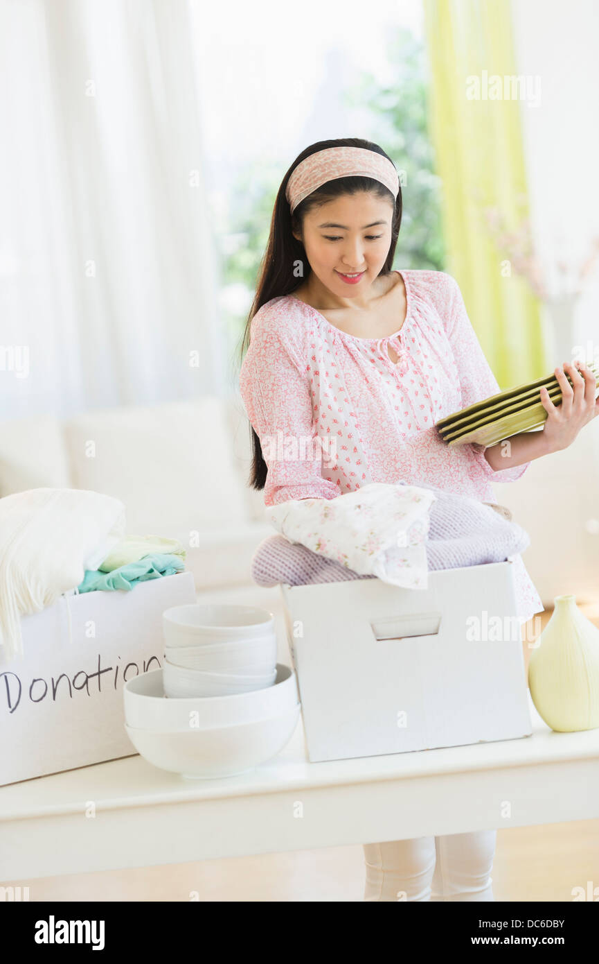 Woman donating household items Stock Photo - Alamy