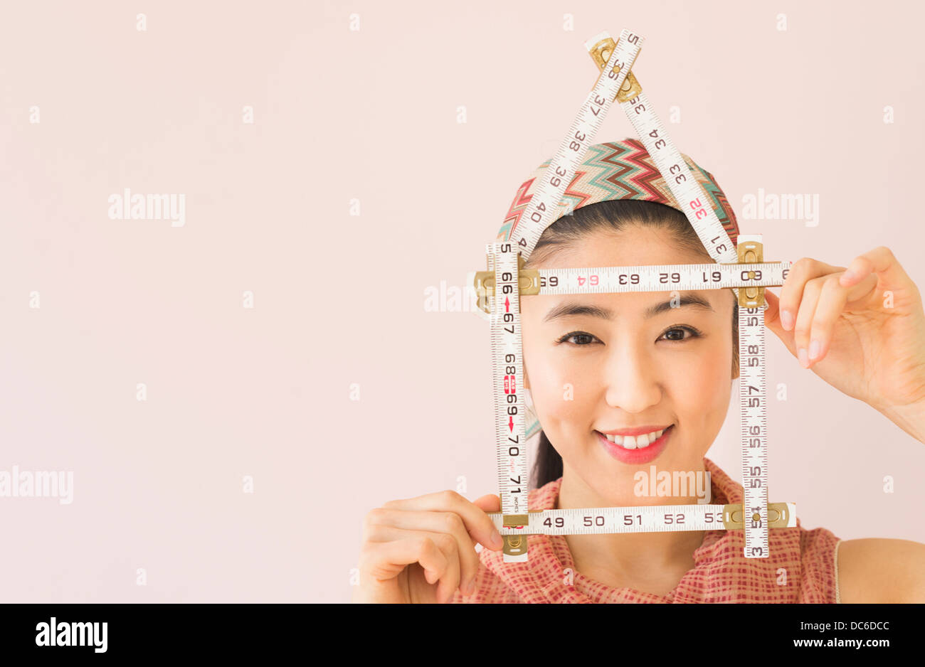 Woman holding tape measure Stock Photo - Alamy