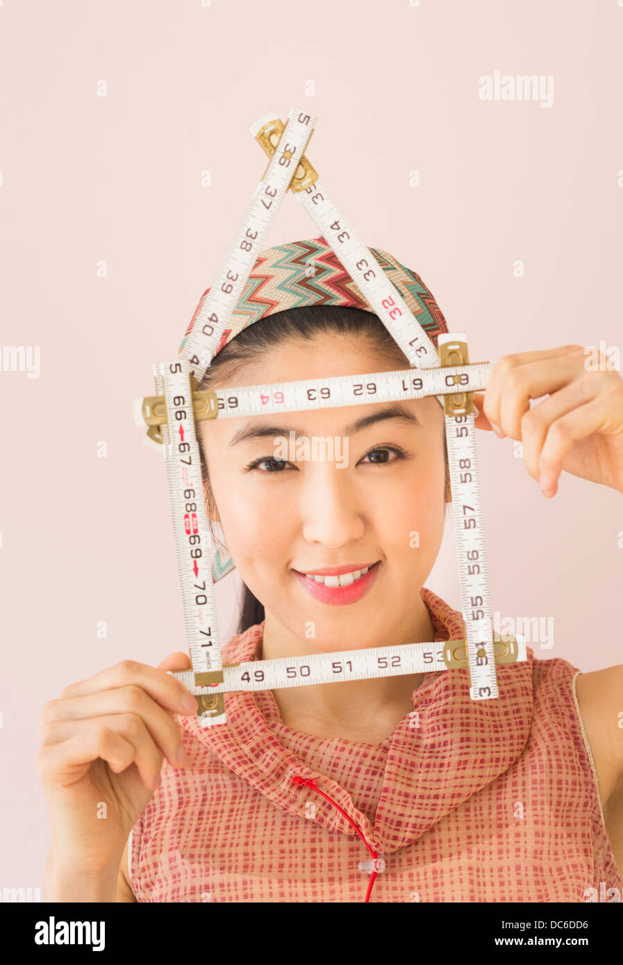 Woman holding tape measure Stock Photo - Alamy