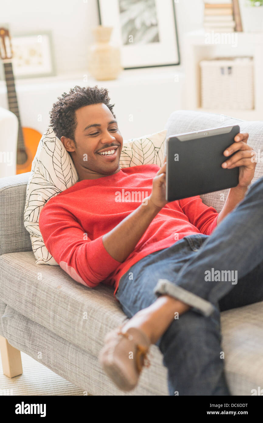 Man using tablet lying hi-res stock photography and images - Alamy