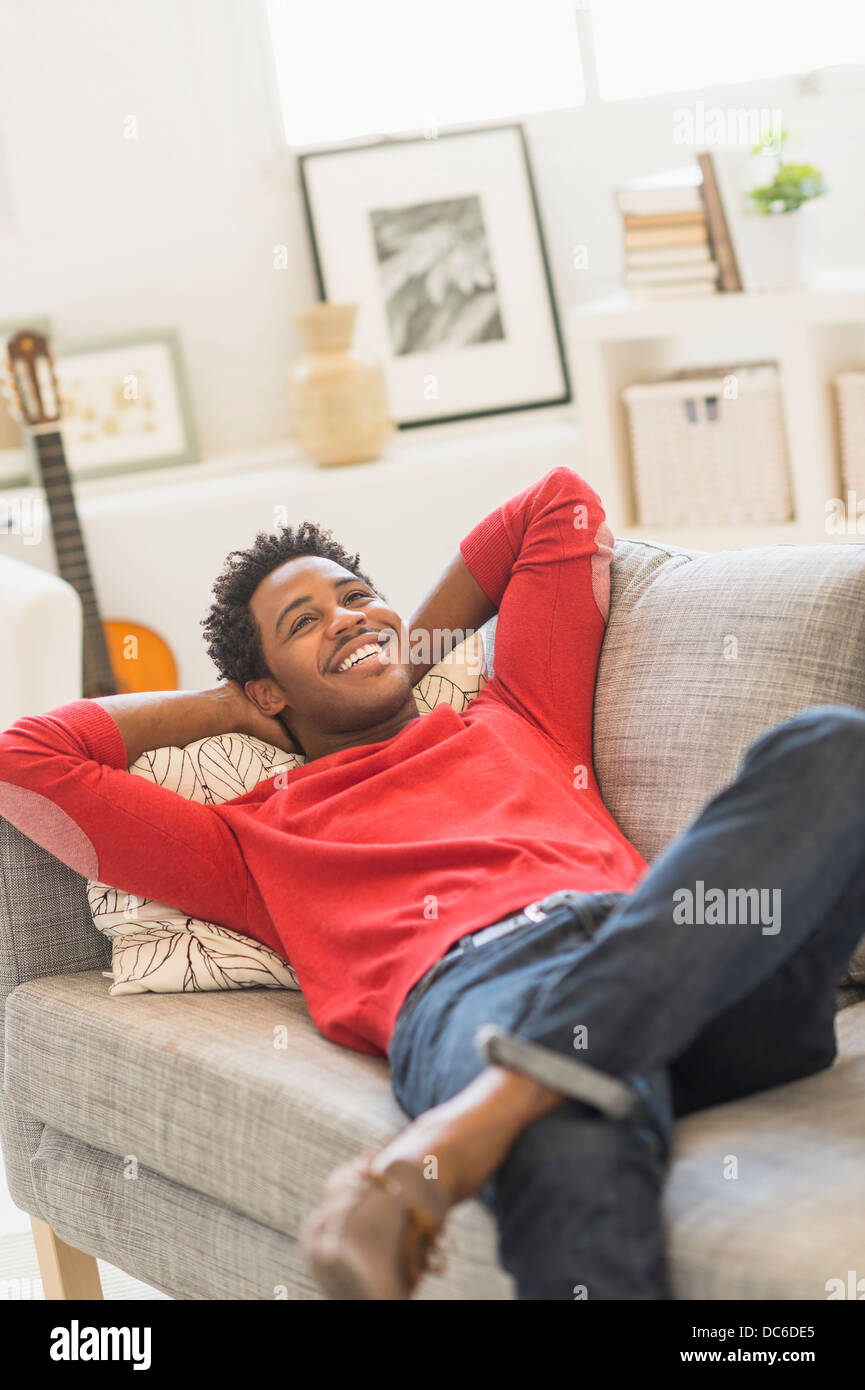 Male lying on sofa hi-res stock photography and images - Alamy