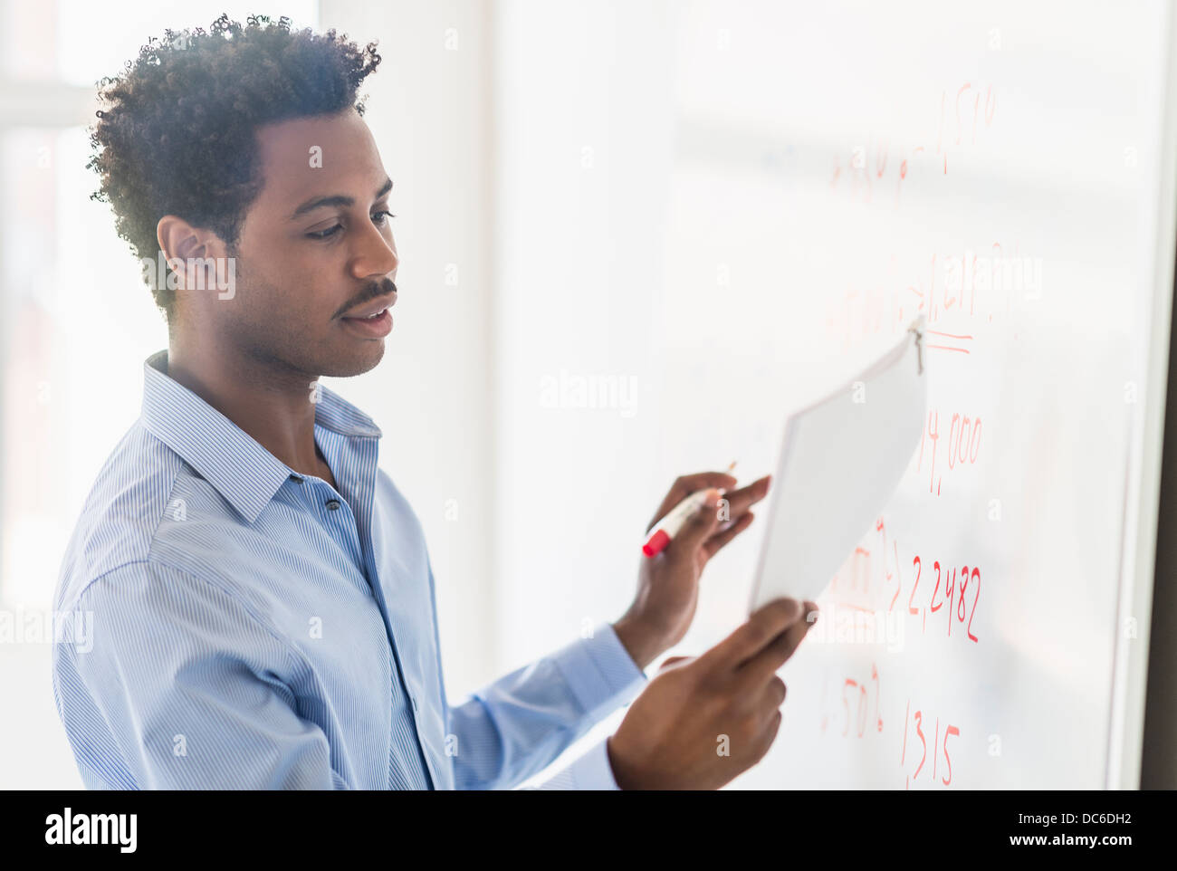 Businessman writing on whiteboard Stock Photo - Alamy