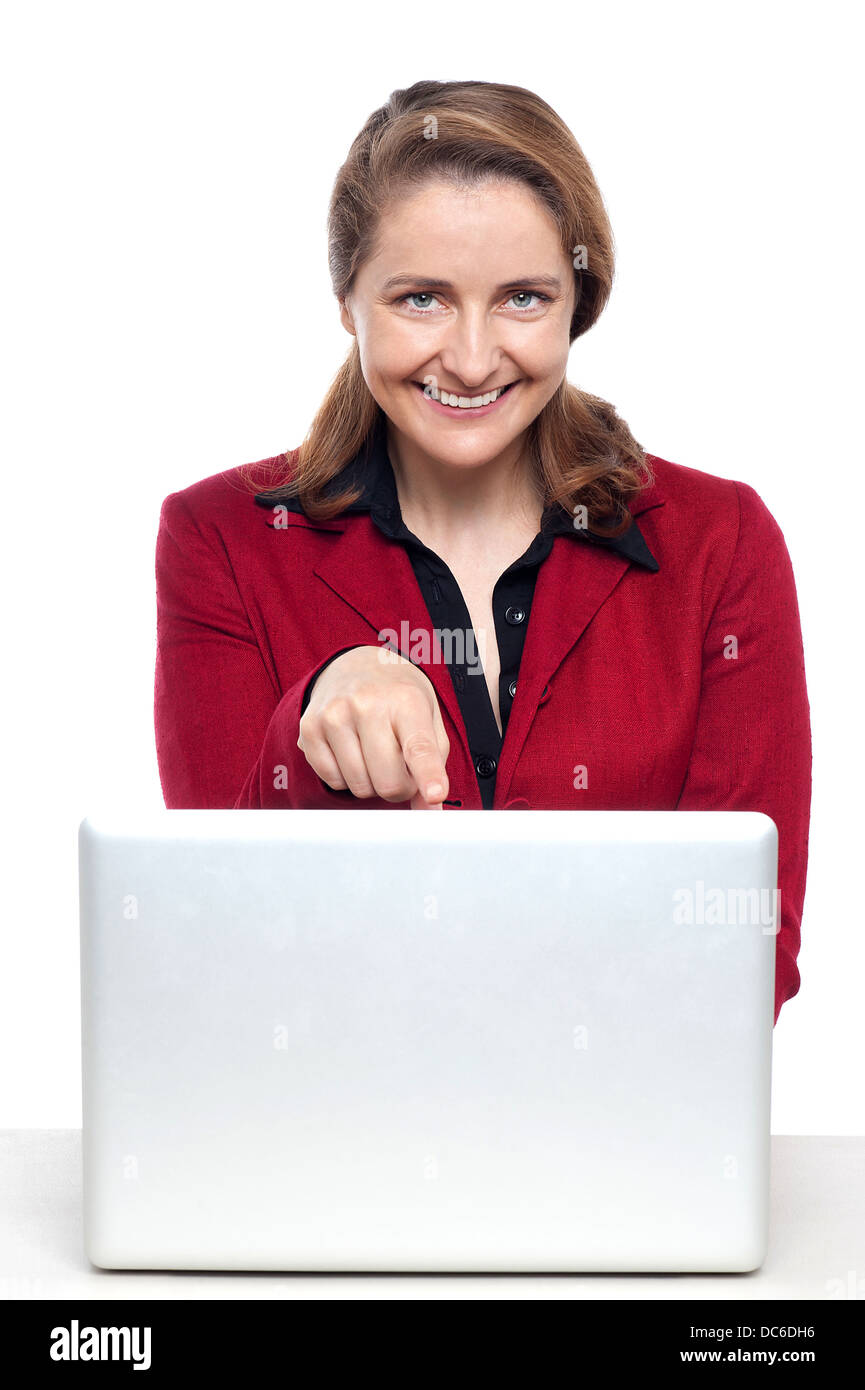 Female business executive pointing at laptop Stock Photo - Alamy