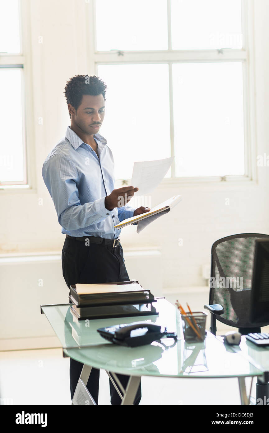 African businessman reading documents hi-res stock photography and ...