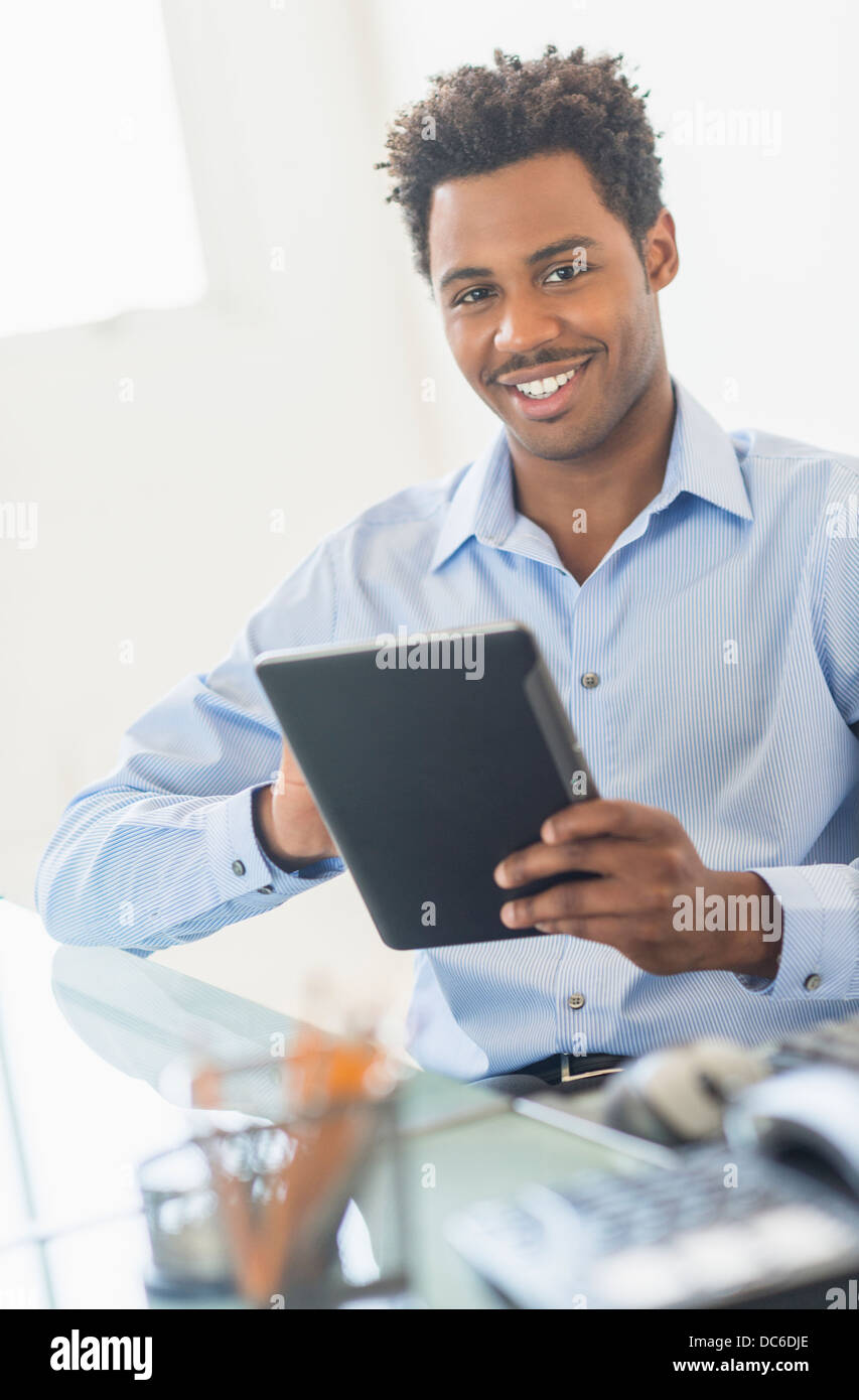 Businessman using tablet PC in office Stock Photo - Alamy
