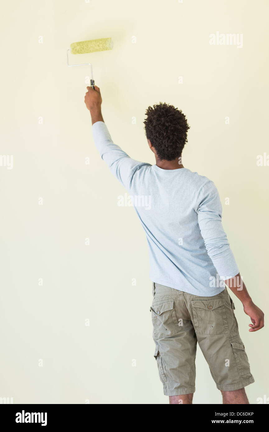Man painting wall Stock Photo - Alamy