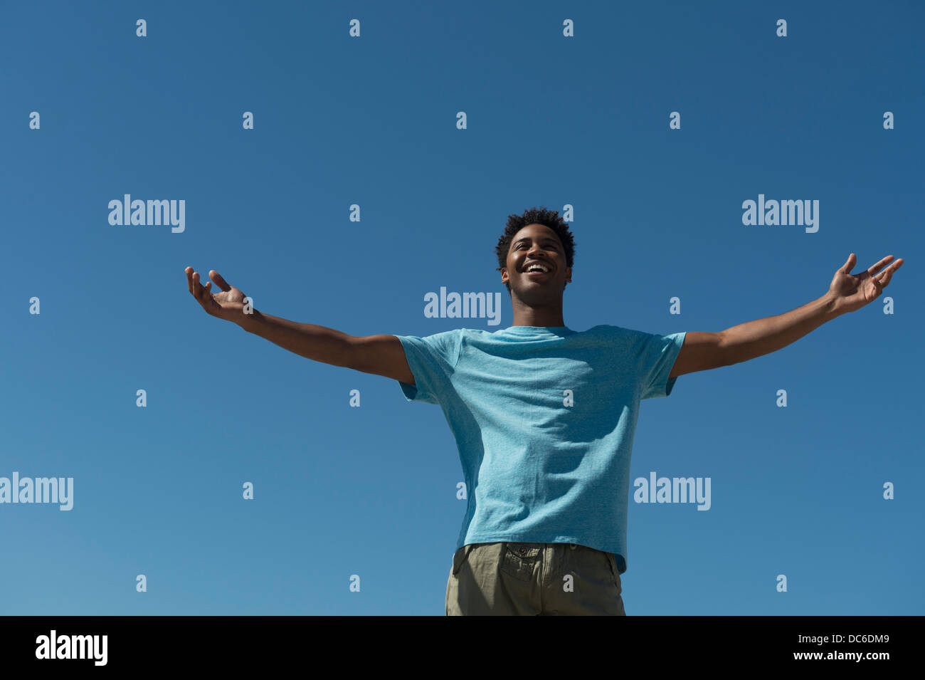 Man standing arms up hi-res stock photography and images - Alamy