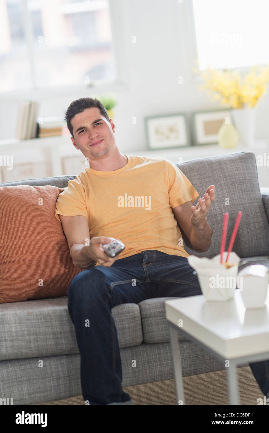 Man eating take out meal and watching television Stock Photo - Alamy