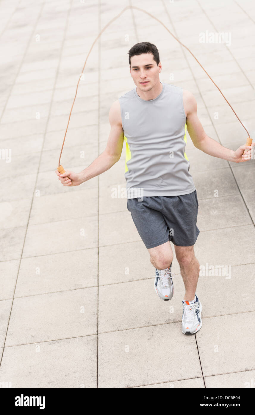 Man exercising with jumping rope Stock Photo - Alamy