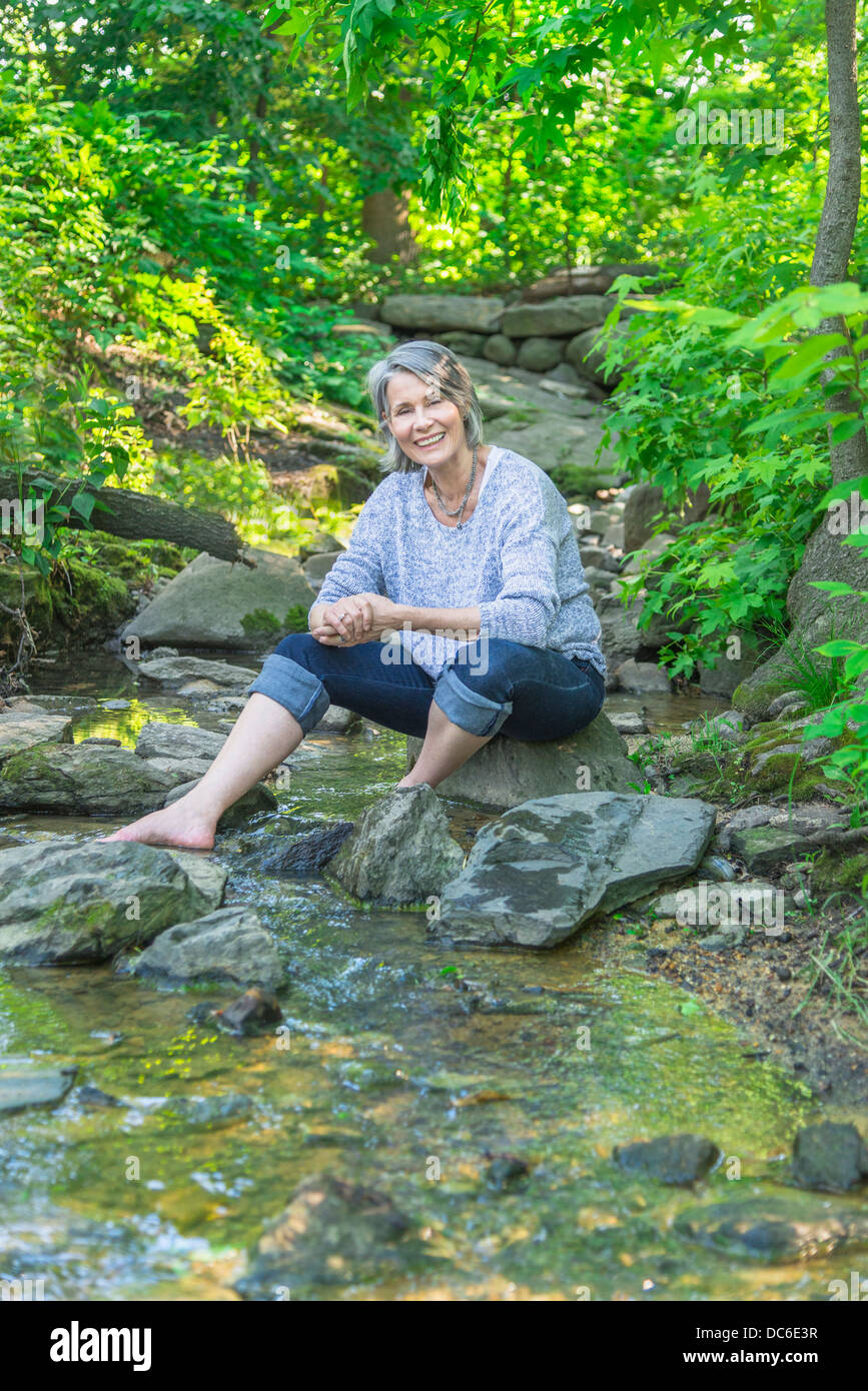 USA, New York State, New York City, Central Park, Senior woman sitting ...