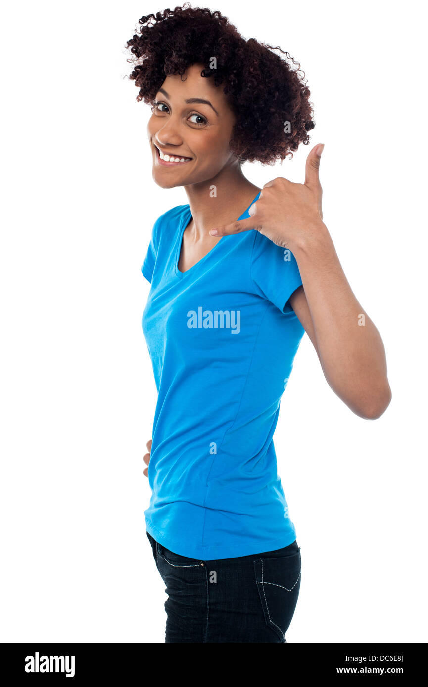 Attractive young model gesturing a mock call Stock Photo - Alamy