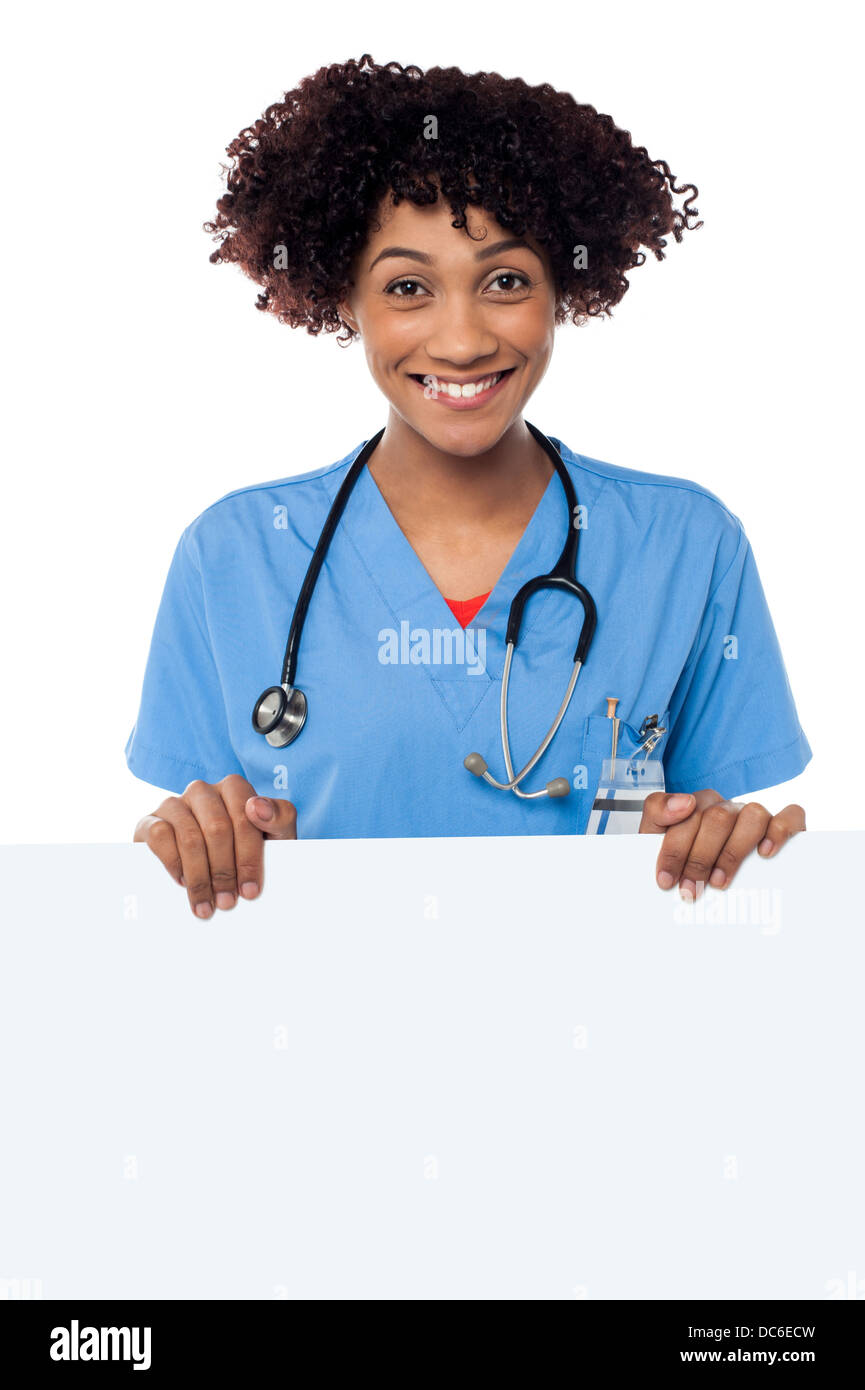 Joyous female doctor standing behind ad board Stock Photo - Alamy